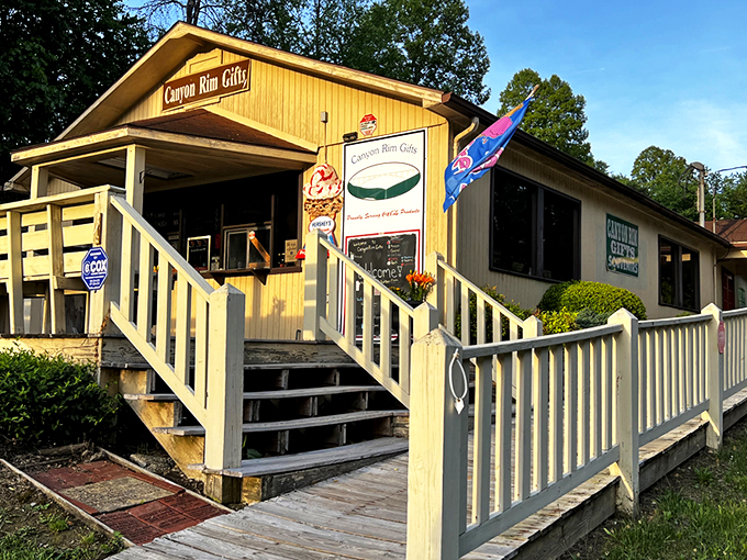 The sunny yellow exterior of Canyon Rim Gifts beckons travelers like a folksy lighthouse amid the West Virginia mountains, promising treasures within. 