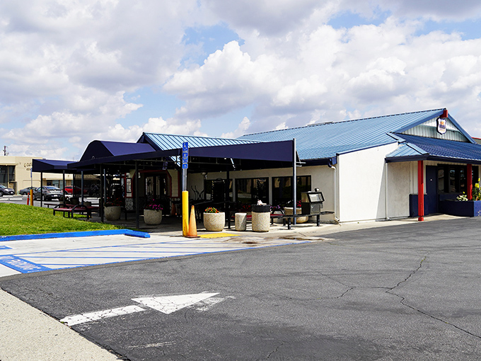 The blue-roofed sanctuary of breakfast dreams awaits on Route 66, where hungry pilgrims find solace in sizzling skillets and coffee refills.