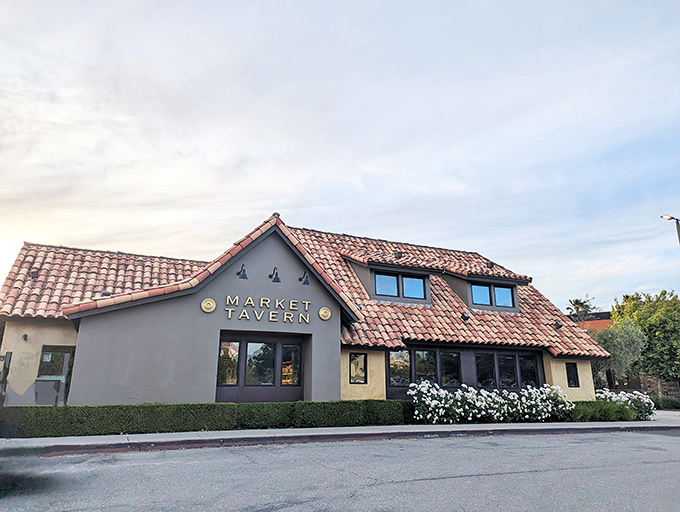 The Spanish-style terracotta roof and inviting facade of Market Tavern stands like a Mediterranean oasis in Dublin, California's suburban landscape.