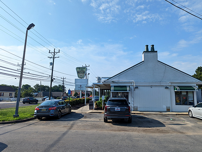 The classic white exterior of College Park Diner stands like a time capsule on Baltimore Avenue, its vintage sign promising comfort food salvation to hungry Marylanders.