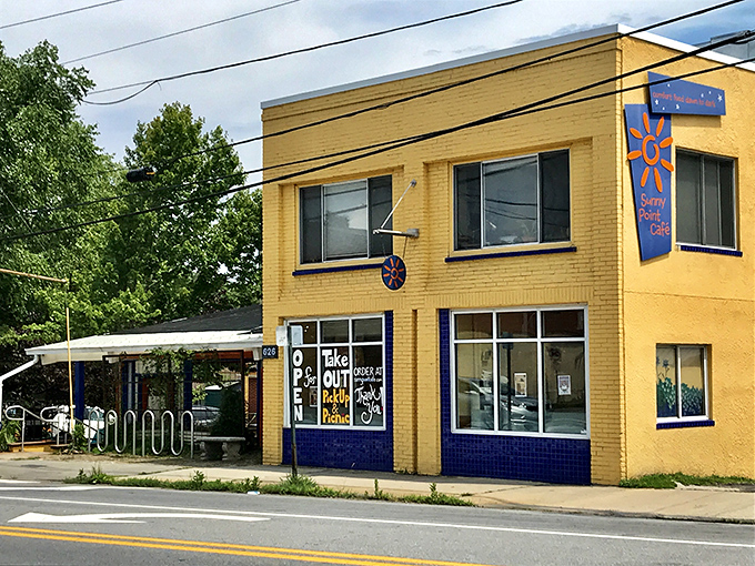 The cheerful yellow exterior of Sunny Point Cafe stands like a beacon of breakfast hope on West Asheville's bustling corridor.