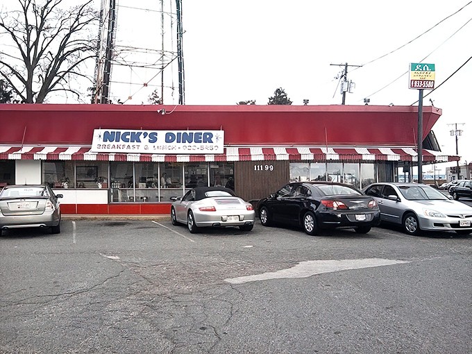 A beacon of breakfast bliss! Nick's Diner's vibrant red exterior is like a siren call to hungry souls, promising comfort food and nostalgia in equal measure.
