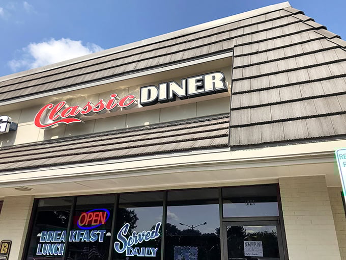 The shingled exterior of Classic Diner beckons with its bold red script and neon promise of daily breakfast. Some buildings just look like they know how to feed you right.