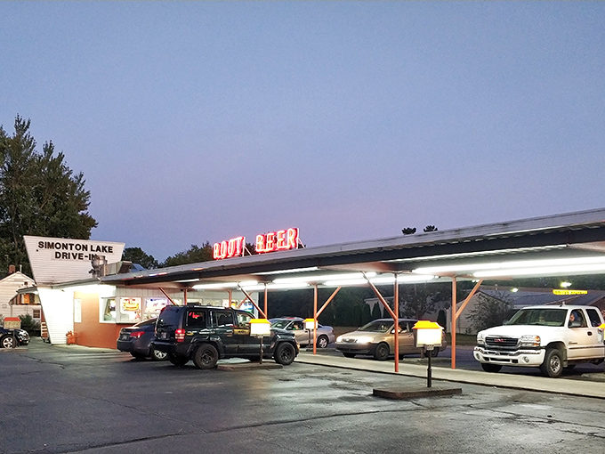 The classic neon "ROOT BEER" sign glows like a beacon to hungry travelers, promising nostalgic flavors under the Indiana sky.