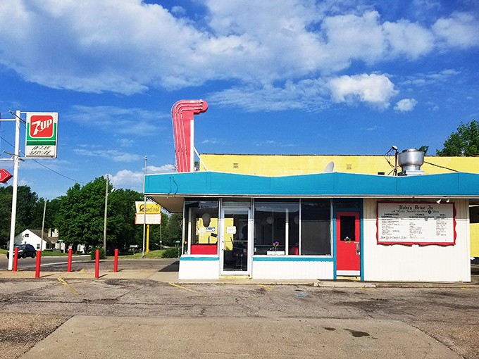 A slice of Americana stands proudly against the Kansas sky, its turquoise trim and cherry-red accents promising delicious nostalgia by the plateful.
