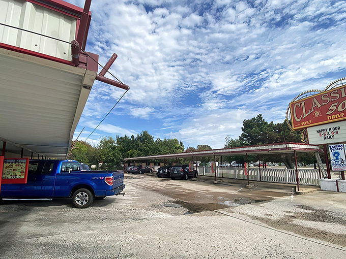 That iconic sunburst sign isn't just advertising&mdash;it's a time machine disguised as a drive-in. The red and white awning beckons like a burger beacon on the horizon.