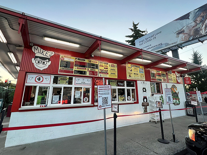 The iconic red and white exterior of Mike's Drive-In stands as a beacon of burger perfection in Milwaukie, welcoming hungry visitors with retro charm. 