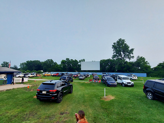 Cars lined up under the open sky, where the humble drive-in transforms ordinary evenings into cinematic adventures. Pure Americana at its finest.