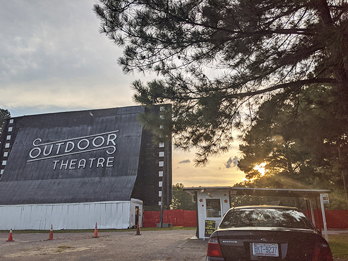 The iconic screen stands tall against the twilight sky, a weathered sentinel guarding decades of cinematic memories.