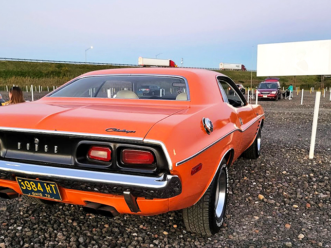 Twilight magic unfolds as cars gather beneath the massive screen, nature providing the perfect backdrop for cinema under an Ohio sunset.