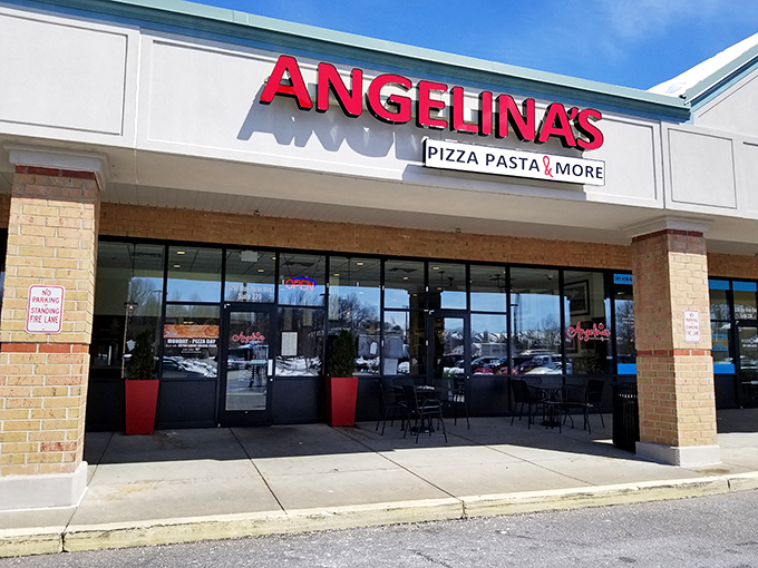 The bright red signage beckons like a lighthouse for the pasta-starved. Come for the promise of "Pizza Pasta & More," stay for the red umbrella charm.