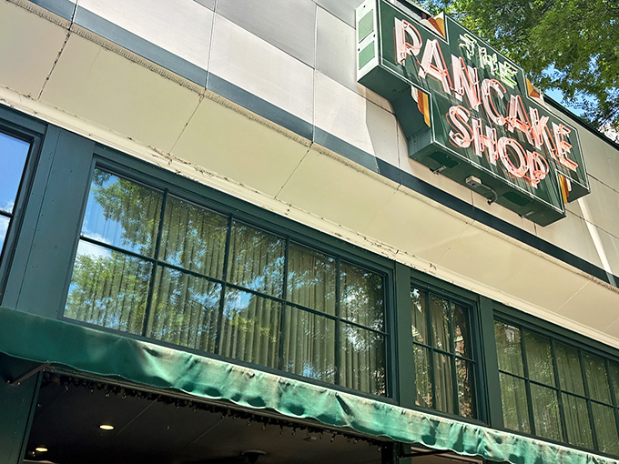 The iconic green sign beckons like a breakfast lighthouse on Central Avenue, promising pancake paradise to early risers and brunch enthusiasts alike.
