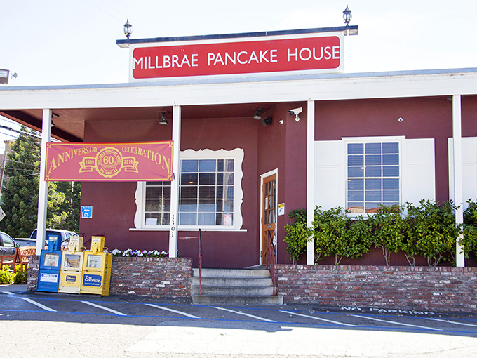 The iconic red sign beckons like a lighthouse for breakfast lovers. This unassuming burgundy building has launched a thousand food comas.