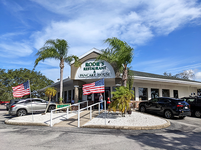 Sunshine, palm trees, and pancakes &ndash; Rodie's exterior promises Florida charm with its welcoming entrance and twin American flags fluttering in the Gulf breeze.