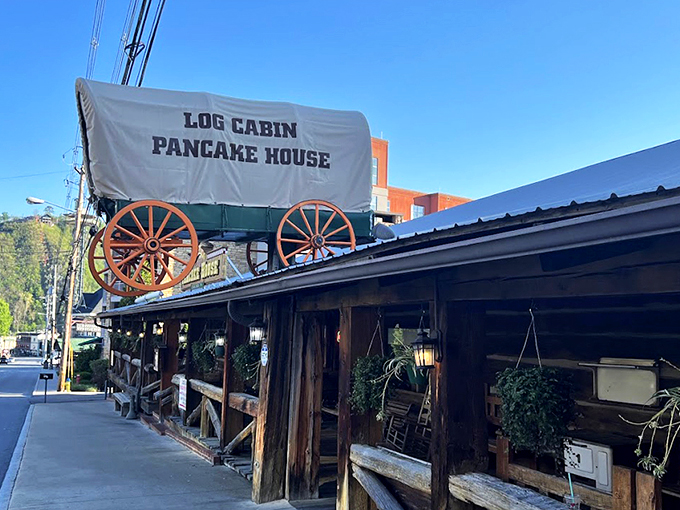 The iconic covered wagon sign welcomes hungry travelers like a beacon of breakfast hope on Gatlinburg's bustling parkway.