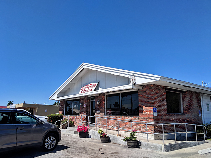 The unassuming brick exterior of Dixie Fried Chicken stands like a temple to simplicity&mdash;proof that culinary greatness doesn't need fancy architecture.