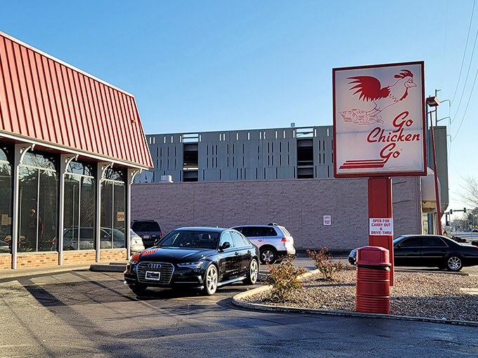 The iconic red-roofed building with its distinctive running chicken sign stands as a beacon of fried chicken perfection in Kansas City. 