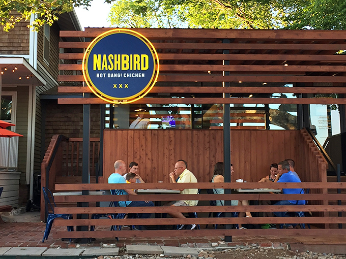 Nashbird's rustic wooden exterior isn't just Instagram-worthy&mdash;it's a siren call to chicken lovers everywhere. The circular yellow sign promises delicious things await.