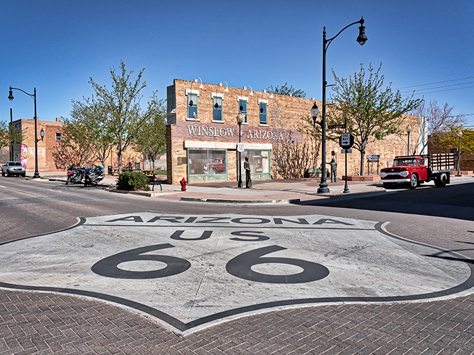 The famous corner in Winslow, Arizona, complete with Route 66 shield painted right on the pavement. Rock and roll geography at its finest!