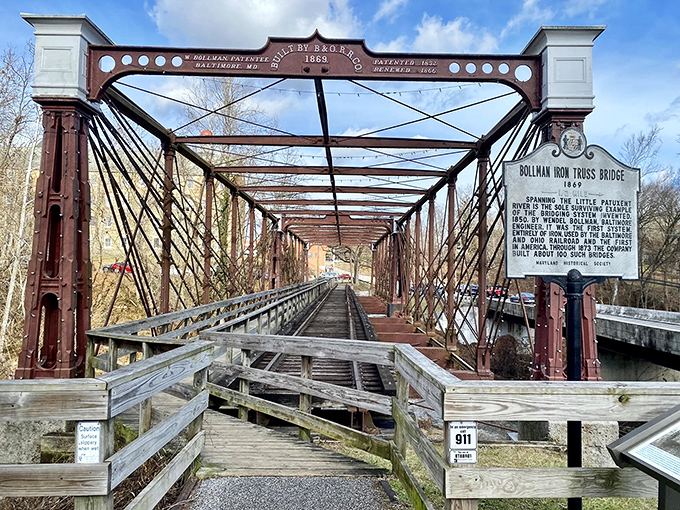 The historic Bollman Truss Bridge stands as an iron sentinel over time, its burgundy framework a perfect backdrop for selfies that'll make your Facebook friends jealous.