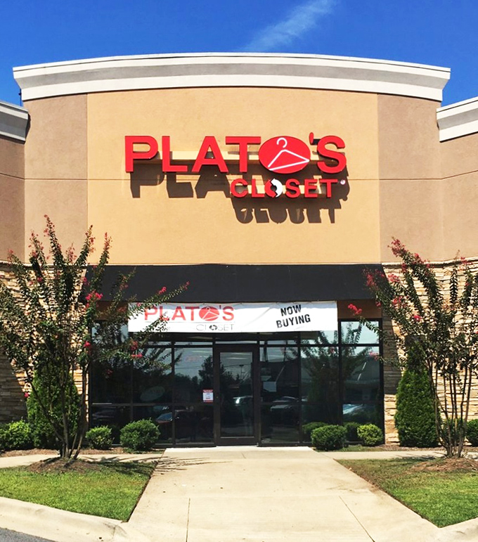The tan fa&ccedil;ade and bold red signage of Plato's Closet beckons like a fashion oasis in the suburban retail landscape.