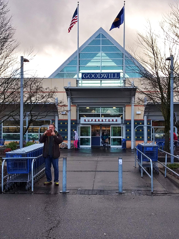 The iconic triangular entrance to Goodwill's Portland superstore stands like a beacon for treasure hunters, promising adventures in secondhand shopping beneath those blue letters. 