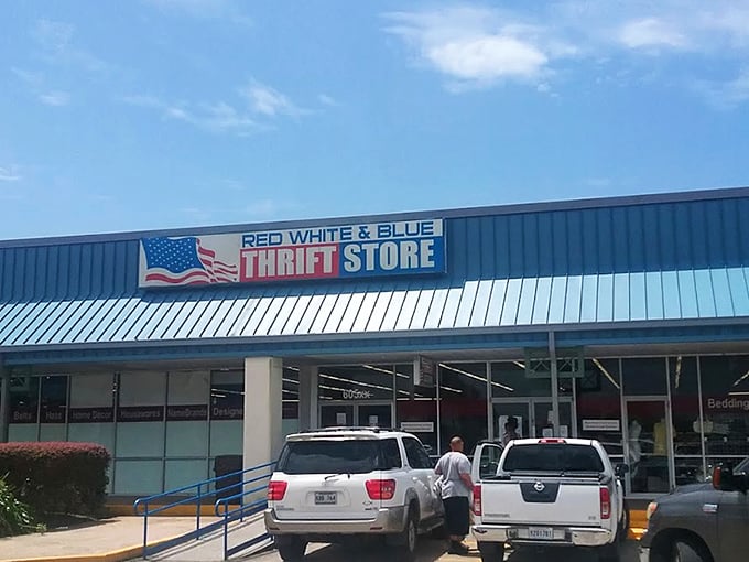 The patriotic facade of Red White & Blue Thrift Store stands like a treasure chest waiting to be opened, promising adventures in secondhand splendor under the Louisiana sun. 