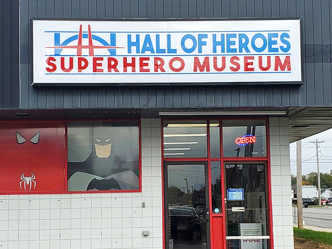 The unassuming exterior belies what waits inside - a fa&ccedil;ade featuring iconic superhero emblems that serve as a bat-signal to comic enthusiasts everywhere.