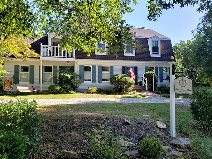 The Miller-Dunham House stands like a Norman Rockwell painting come to life, complete with sunlight filtering through mature trees and a welcoming brick patio.