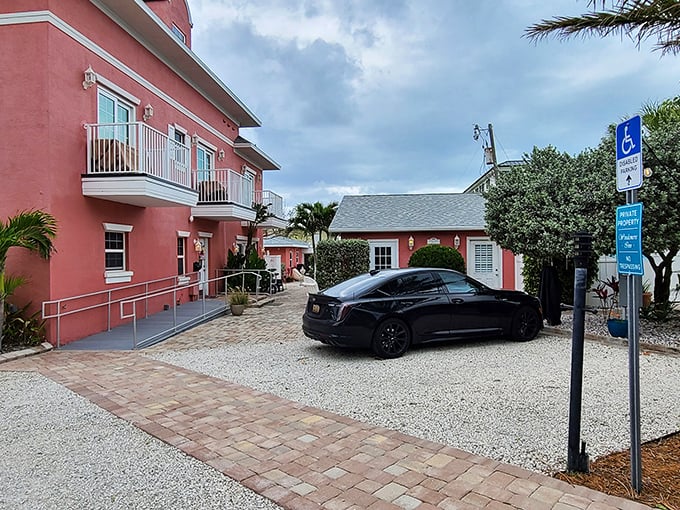 The coral-pink fa&ccedil;ade of Windermere Inn by the Sea stands like a blushing debutante against Florida's blue sky, promising coastal comfort with every white-trimmed window.