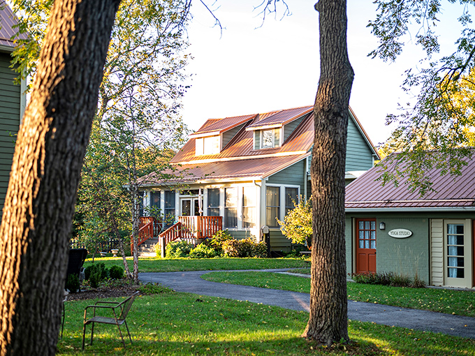 The sage-green farmhouse welcomes you with a porch that practically whispers, "Put down your phone and grab a rocking chair."