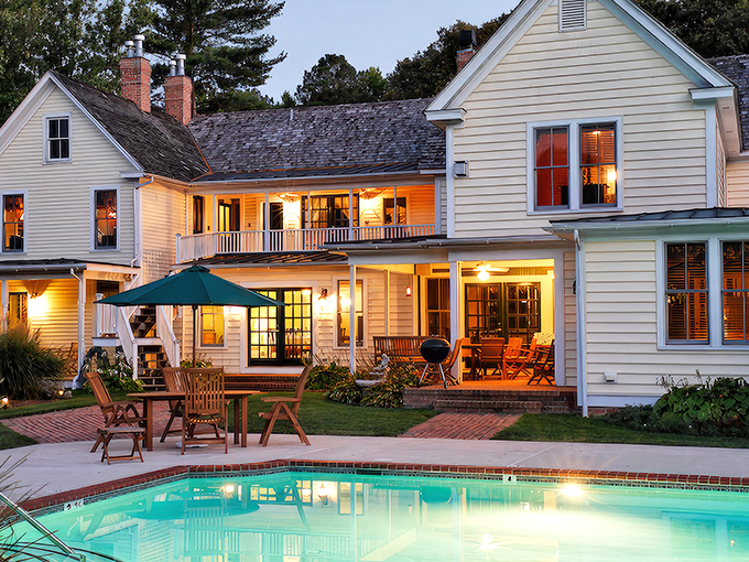 Sunset transforms this Victorian beauty into a watercolor painting come to life. The golden hour glow on that butter-yellow clapboard is nature's perfect filter.