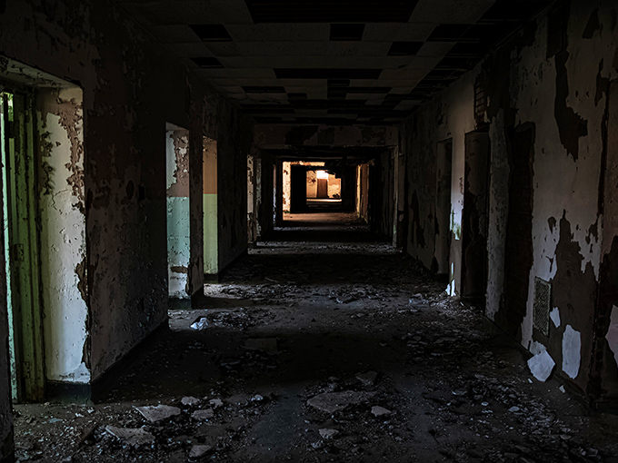 Antique medicine bottles line wooden shelves, silent witnesses to treatments once considered cutting-edge. Each glass vessel tells a story of psychiatric care's troubling evolution. 