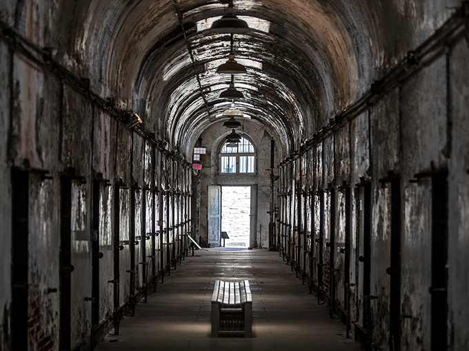 The long corridor stretches into infinity, peeling paint telling more stories than any prison guidebook ever could. History's whispers echo with each step.