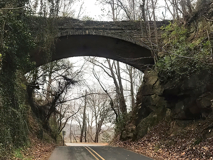 The stone archway of Helen's Bridge emerges from the mist like a portal to another time. Mother Nature's own special effects department working overtime here.