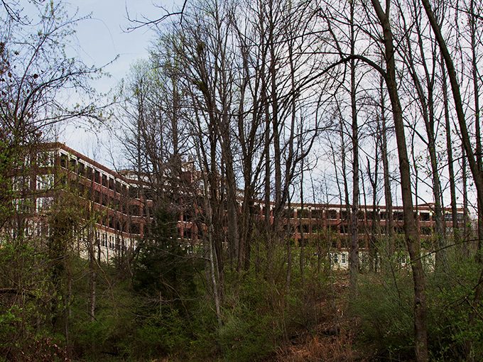 The imposing brick facade of Waverly Hills stands as a silent sentinel, its windows like countless eyes watching your approach with century-old patience. 