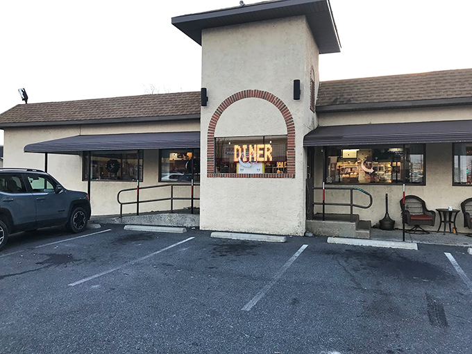 The unassuming exterior of Essex Diner stands like a beacon of comfort food promise. That neon "DINER" sign has been guiding hungry travelers for decades.