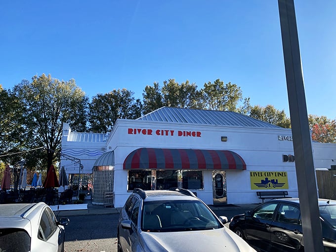 Art deco meets comfort food heaven in this retro-styled exterior. The blue awnings and vintage signage promise a time-traveling culinary adventure.