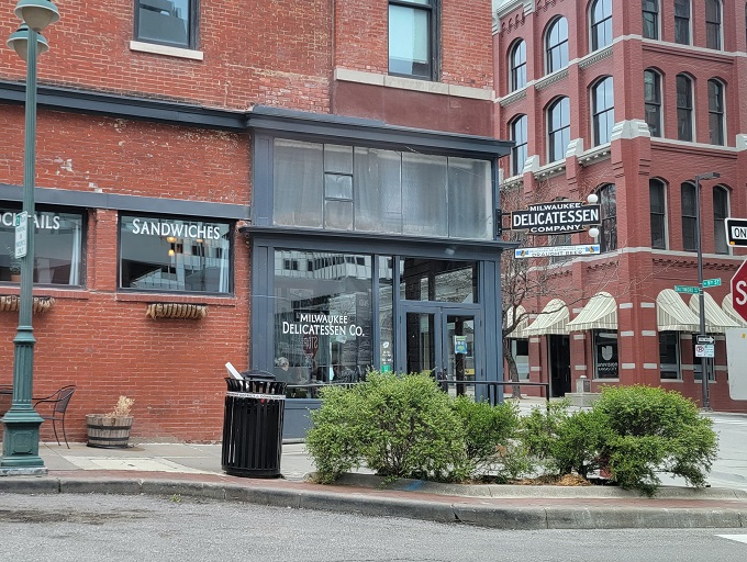The corner brick building stands like a sandwich sentinel, promising delicious treasures within. That vintage sign isn't just decoration&mdash;it's a beacon for the hungry. 