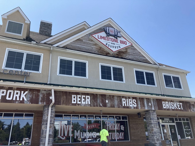 The rustic wooden fa&ccedil;ade of Limestone BBQ and Bourbon promises what every barbecue pilgrim seeks: a temple where smoke, meat, and time create magic.