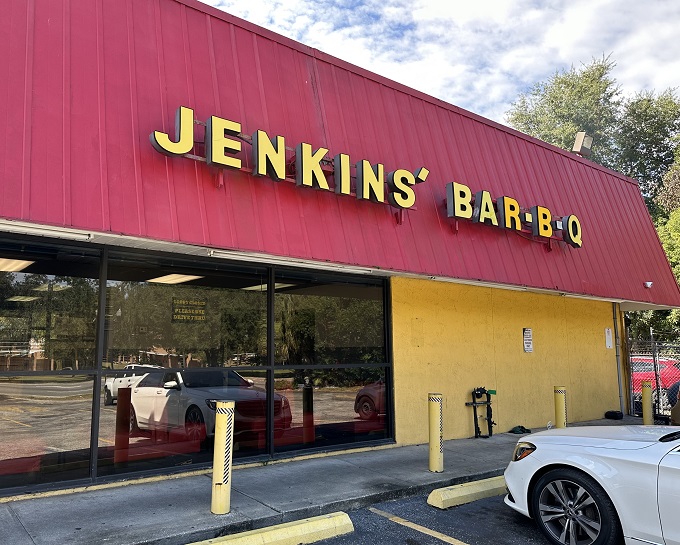 The bright yellow building with its iconic red roof stands like a barbecue beacon in downtown Jacksonville, drawing hungry pilgrims since 1957.
