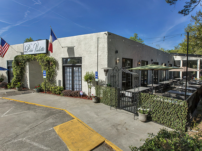 The ivy-draped entrance to Petite Violette beckons like a secret French hideaway. One step through those doors and Atlanta disappears behind you.
