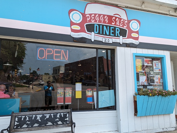 Welcome to Peggy Sue's, where the blue awning beckons like a retro beacon of breakfast bliss. Step inside and prepare for a time-warp to deliciousness!