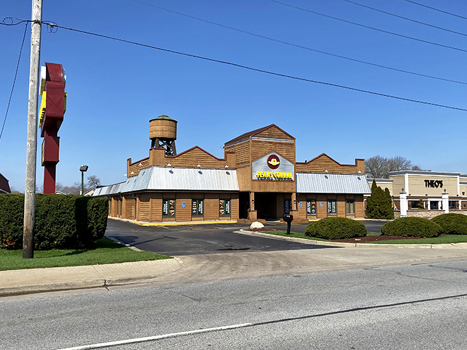 The iconic Texas Corral exterior stands like a Western movie set in suburban Indiana, complete with that charming water tower that says "yes, serious beef happens here."