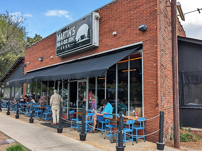 The red brick exterior of Martin's Bar-B-Que Joint beckons hungry pilgrims with its no-nonsense fa&ccedil;ade and the promise of smoky delights within.