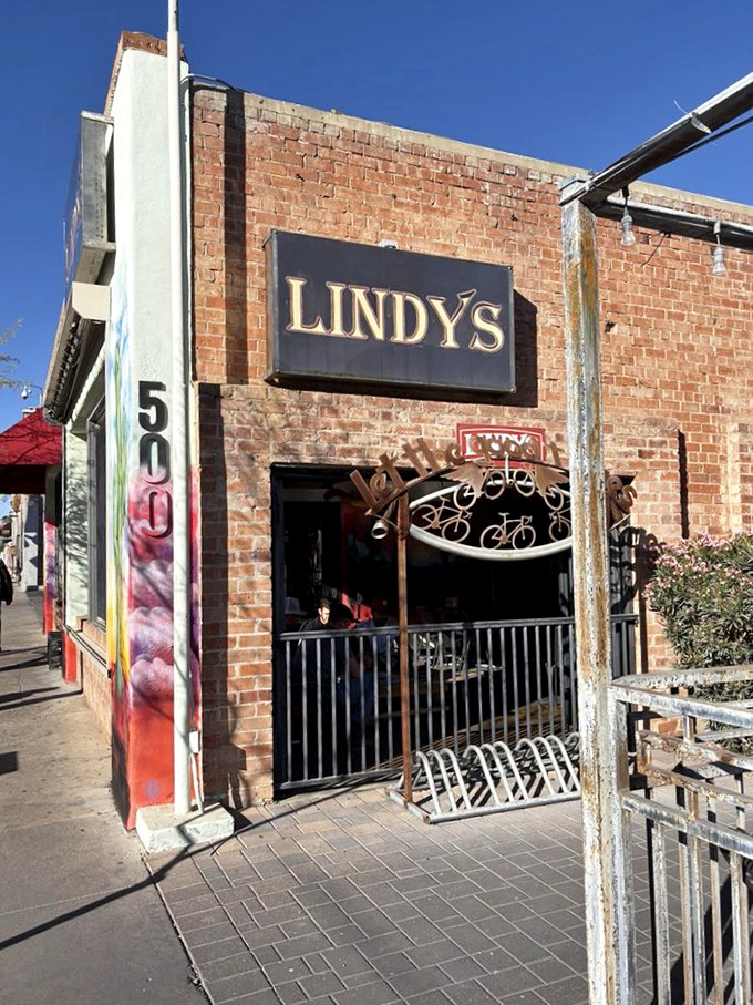 The unassuming brick exterior of Lindy's on 4th, complete with flame accents, stands as Tucson's temple to burger excess. Greatness often hides in plain sight.