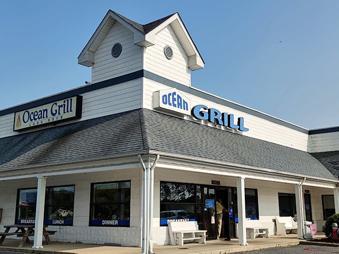 The white clapboard exterior of Ocean Grill stands like a beacon of comfort food promise. Those nautical round windows aren't just for show&mdash;they're portals to flavor town. 