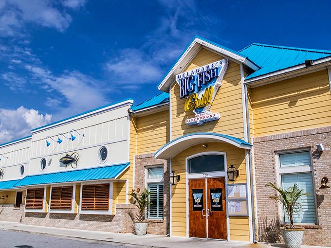 The cheerful yellow exterior of Big Fish Grill beckons like a maritime lighthouse for hungry souls. Blue accents and nautical touches promise seafood salvation ahead.