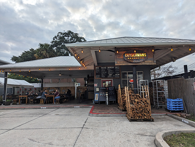 The unassuming exterior of Crydermans hides barbecue greatness like a superhero's secret identity. Stacked firewood isn't decor&mdash;it's a promise of smoky deliciousness to come.