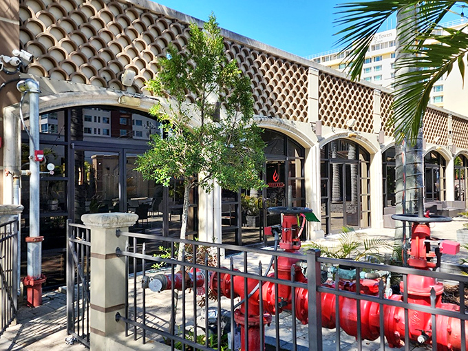 Palm trees sway gently over Ember & Oak's inviting patio, where Florida sunshine and culinary excellence meet in perfect harmony.